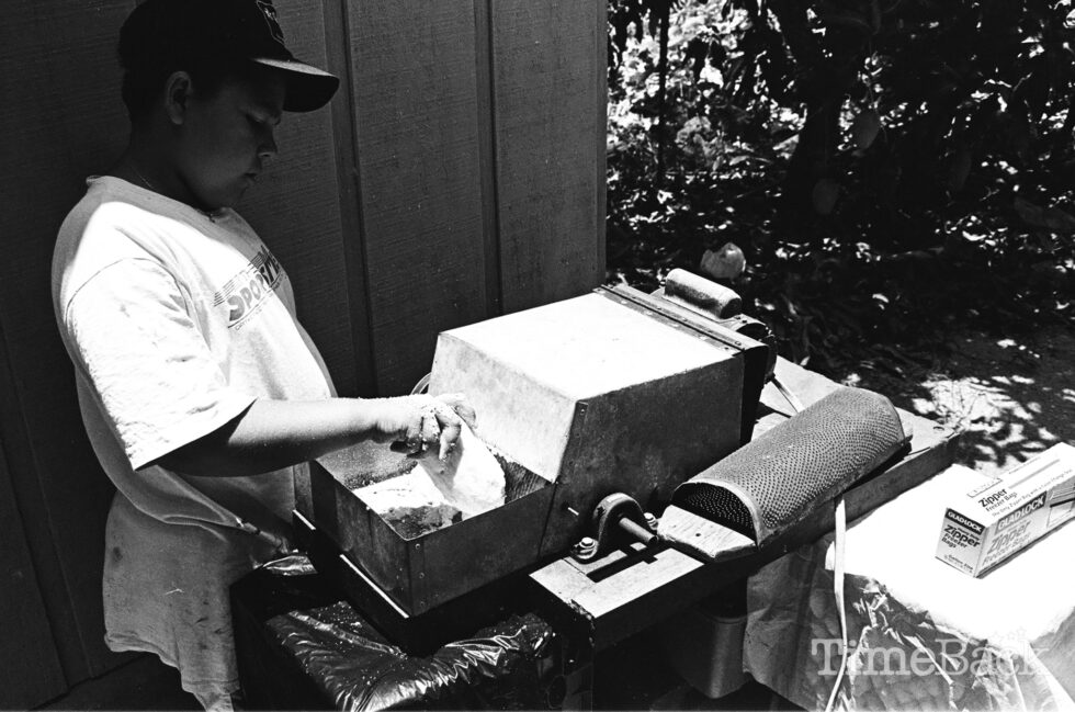 Boy grating cassava, 1992 | TimeBack